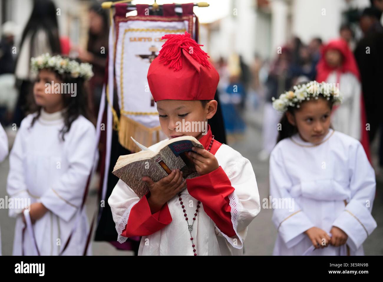Youths attend the Children's Holy Thursday procession during Holy Week ...