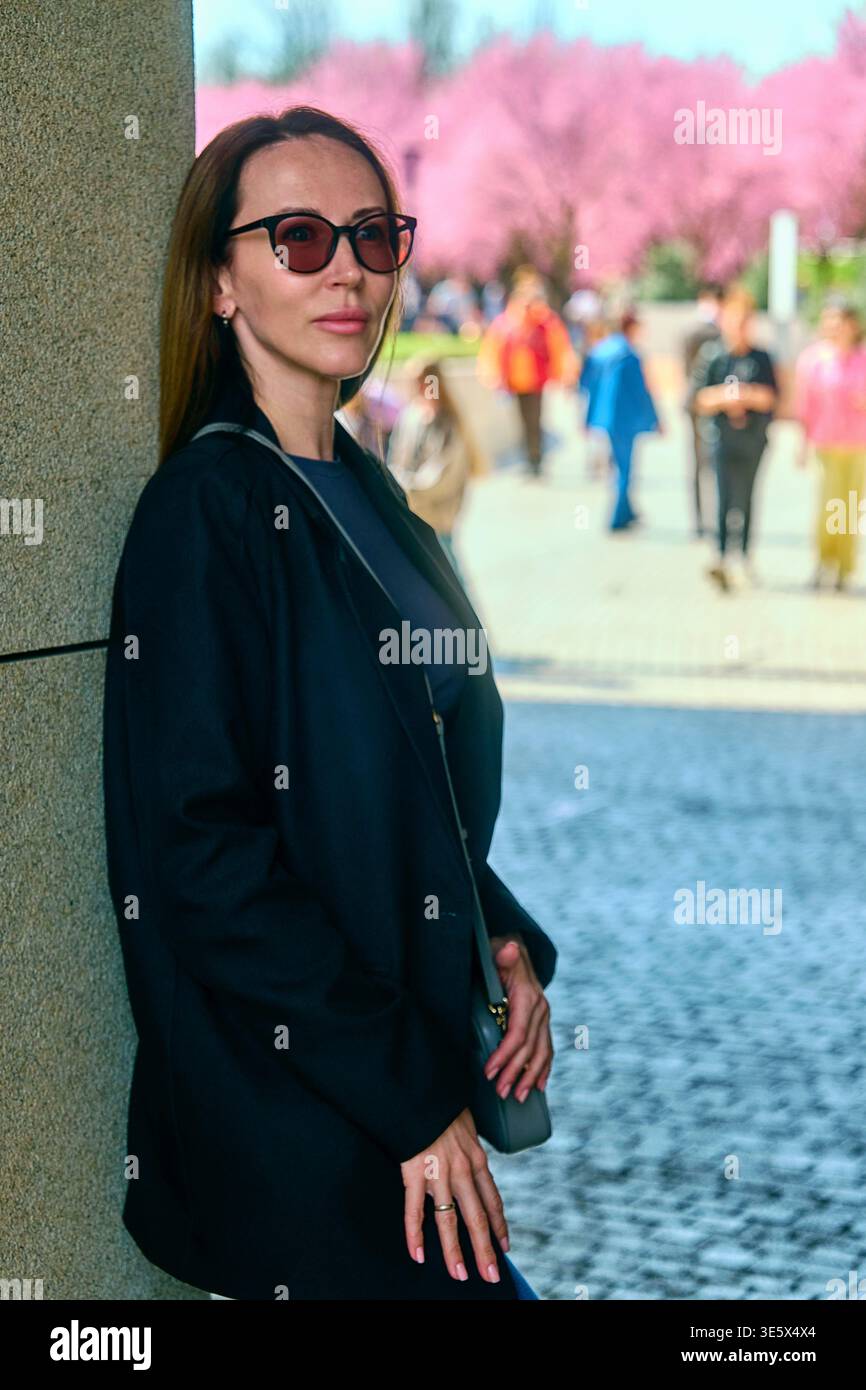 girl walks through a spring park with flowering trees Stock Photo - Alamy
