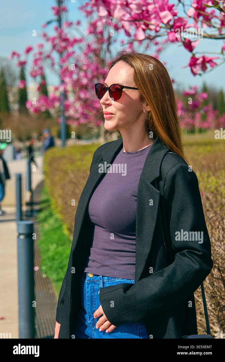 girl walks through a spring park with flowering trees Stock Photo - Alamy