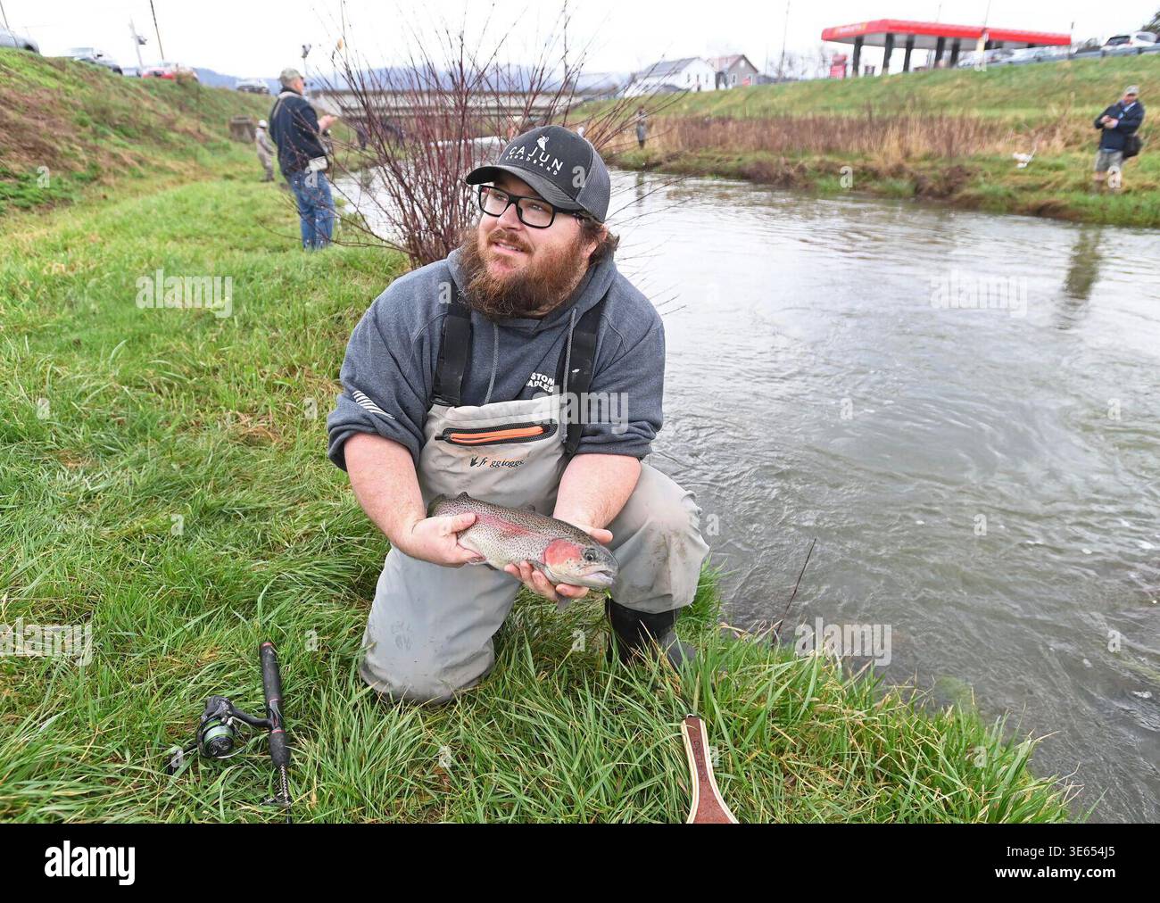 Luke Smithbower of Loretto, PA., shows off a rainbow trout he caught ...