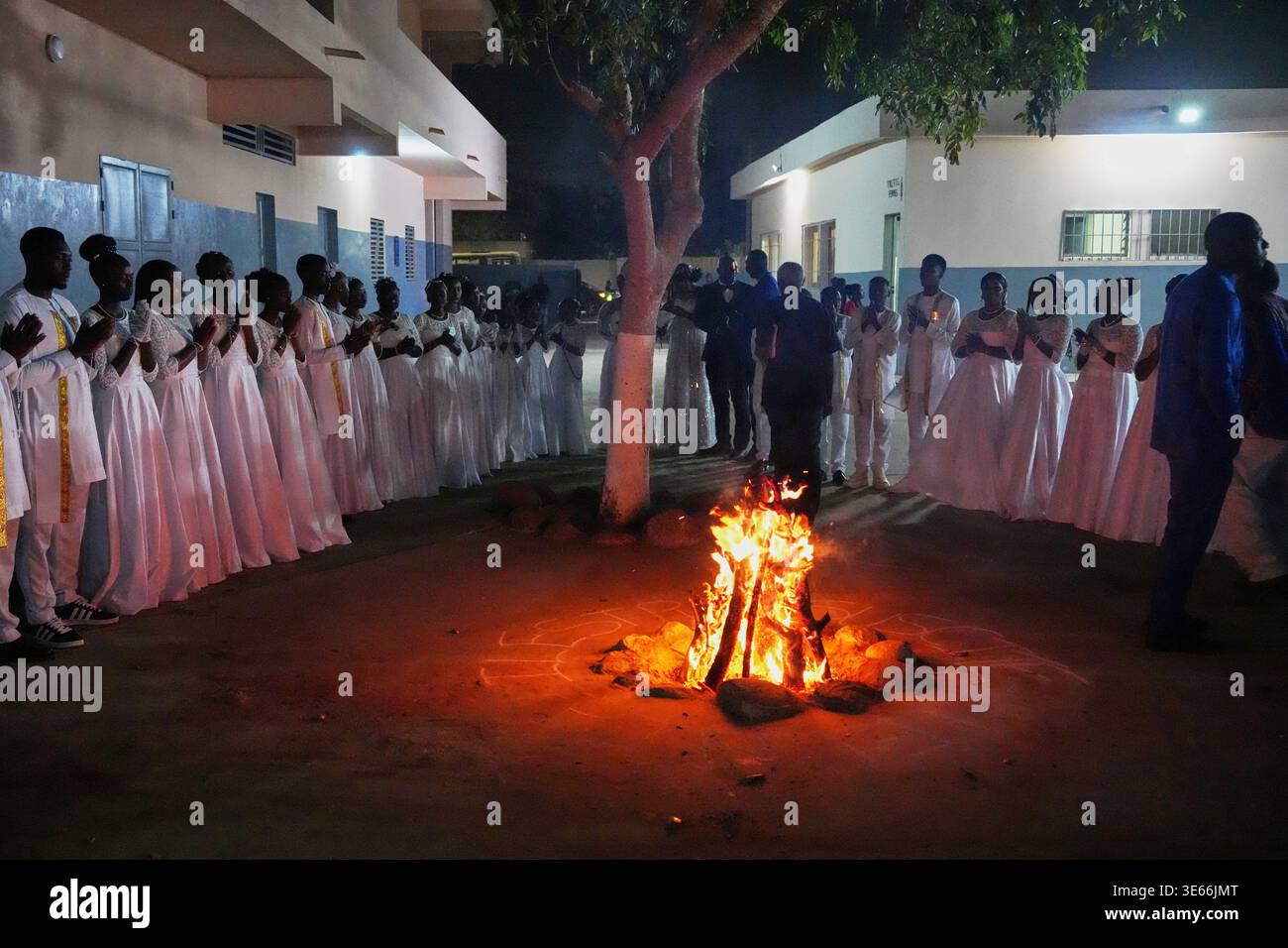 Worshippers who will receive the sacrament of baptism gather around a ...