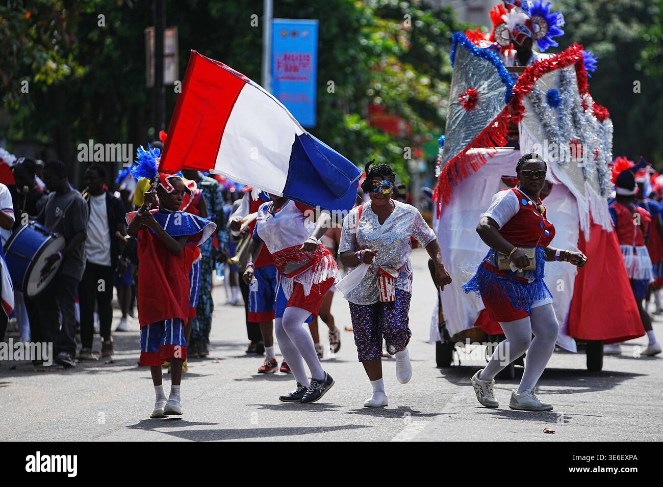 People dressed in costumes perform on the street during the Fanti ...