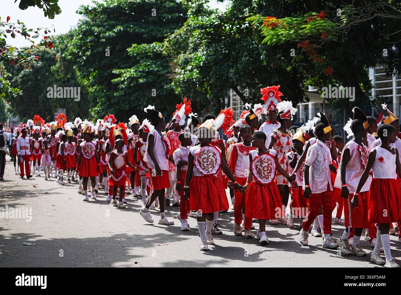 People dressed in costumes perform on the street during the Fanti ...