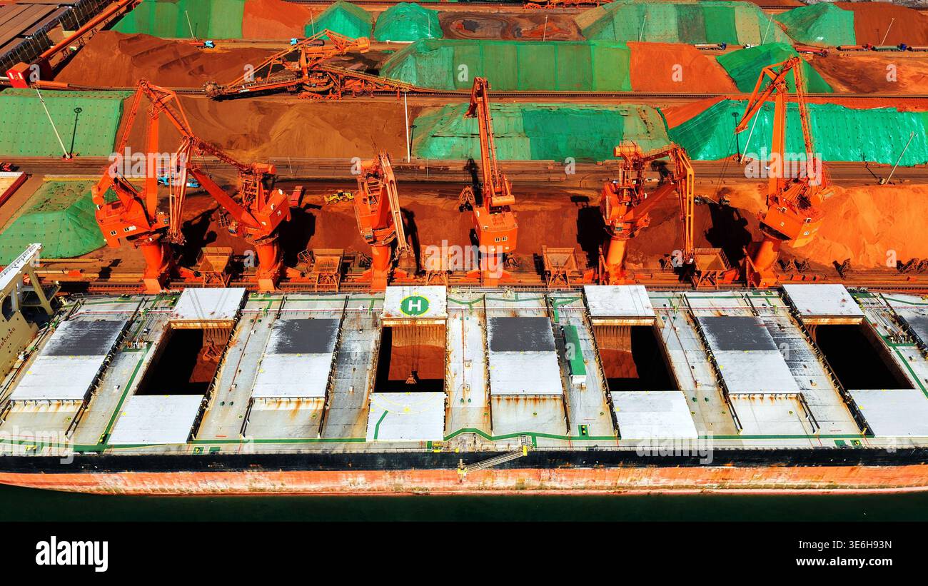 Engineering machinery sorts imported iron ore at Qingdao Port in east ...