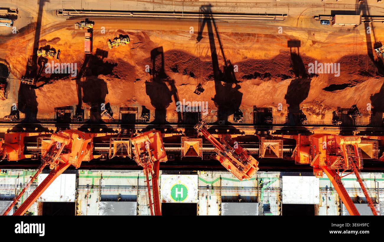 Engineering machinery sorts imported iron ore at Qingdao Port in east ...