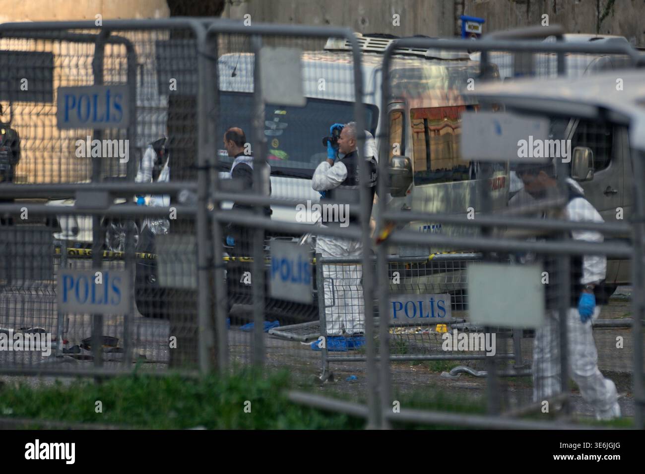 Turkish police investigators work at the site after a gunmen attack at ...