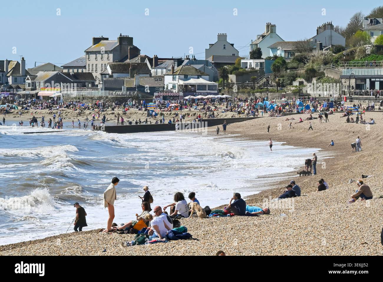 Lyme Regis, Dorset, UK. 7th April 2026. UK Weather. Sunbathers on the ...