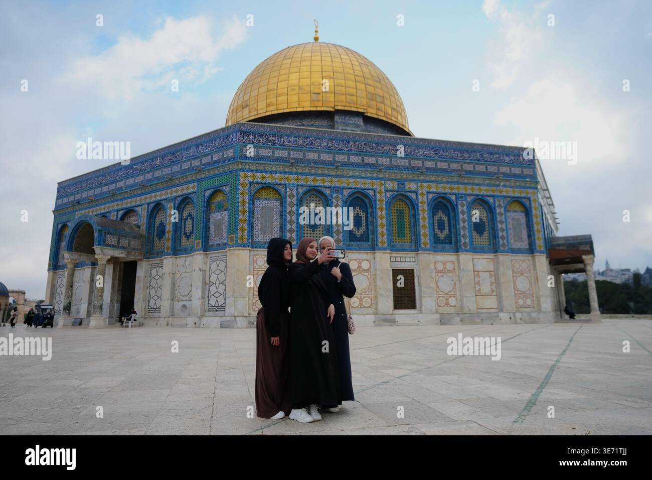 A Muslim women take a selfie next to the Dome of Rock shrine at Al-Aqsa ...