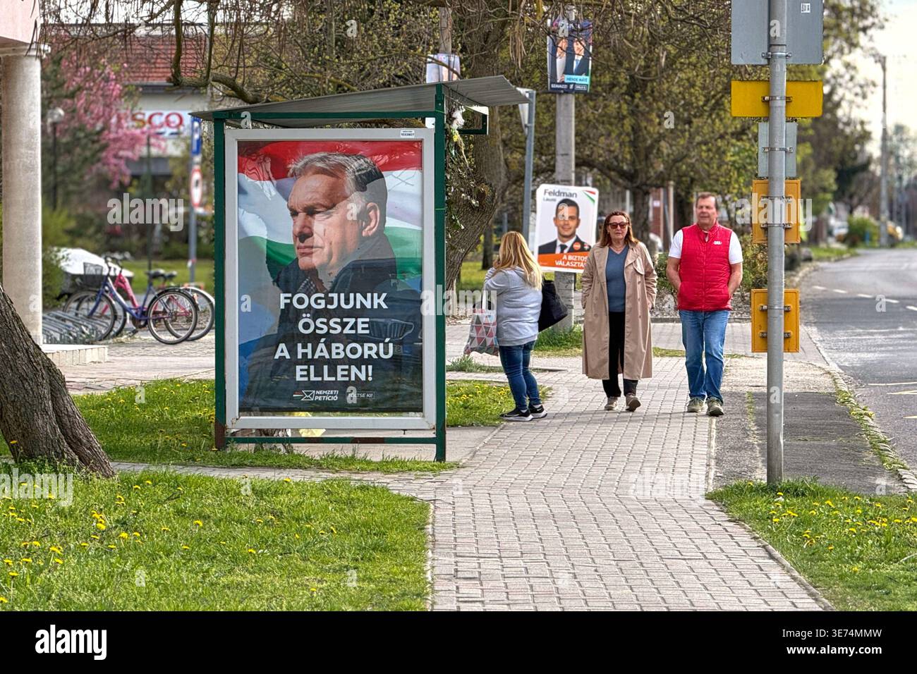 People walk by an electoral poster showing Hungarian Prime Minister ...