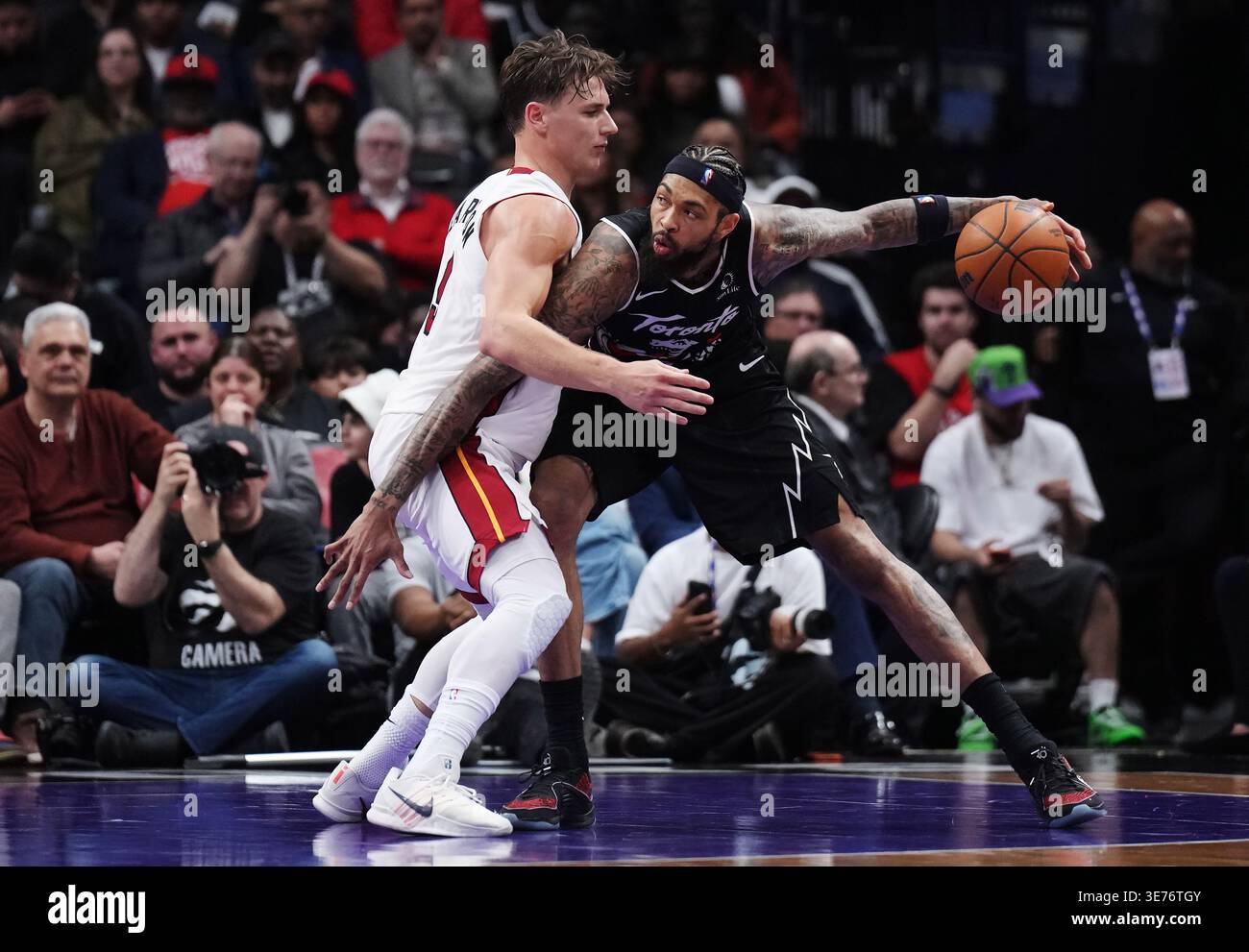 Toronto Raptors' Brandon Ingram (right) protects the ball from Miami ...