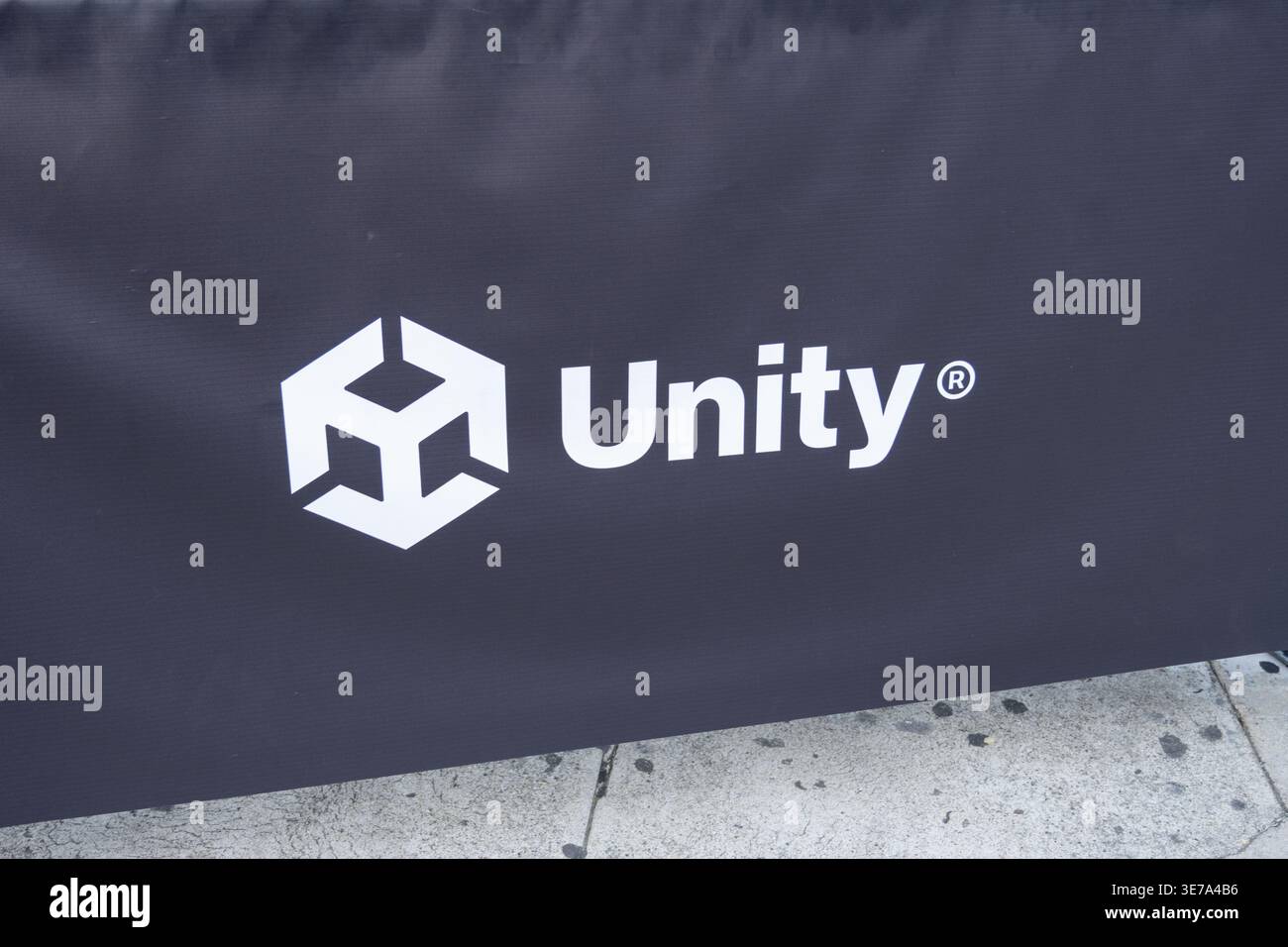 Unity logo and wordmark on black outdoor banner along sidewalk, San ...