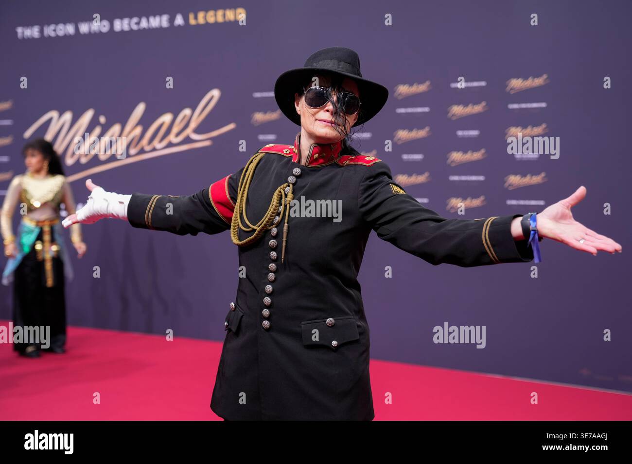 A Michael Jackson fan poses for photographers upon arrival at the ...