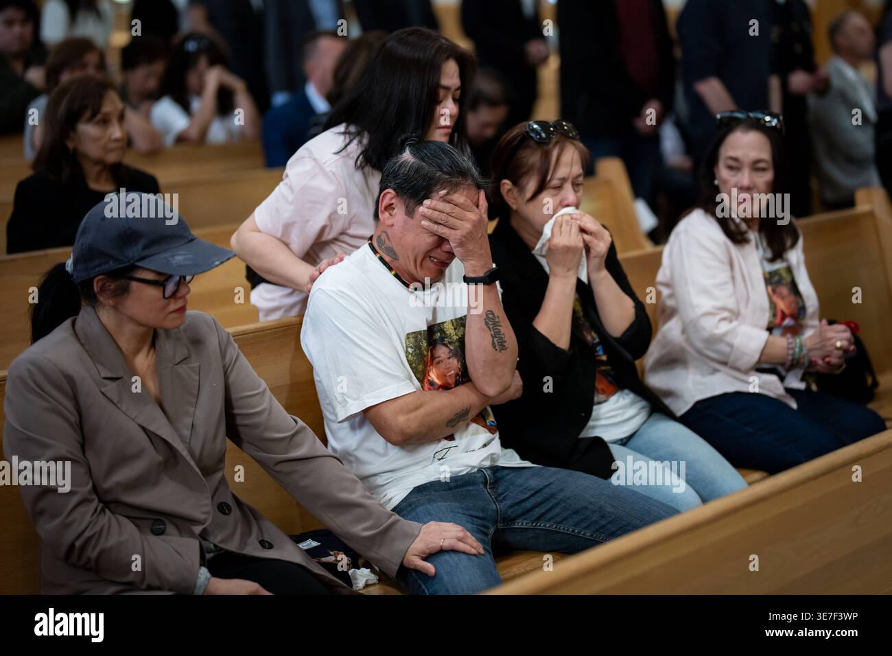 Father of victim Jendhel Sico, Rodel Sico, second from left, holds his ...