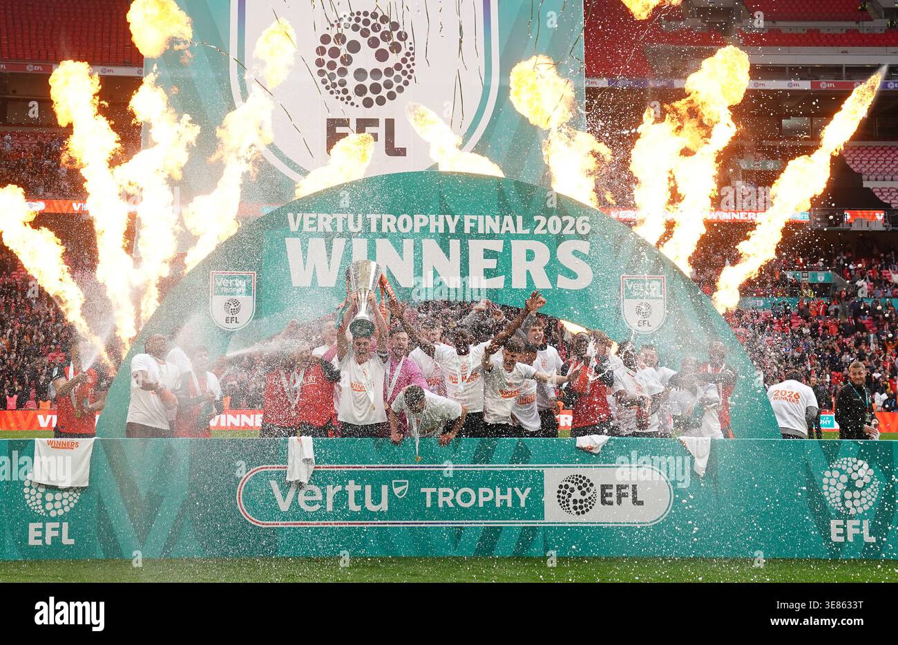 Luton Town players celebrate with the trophy after winning the Vertu ...