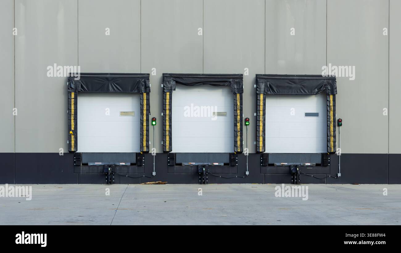 Three empty loading docks with closed doors ready for logistics and ...