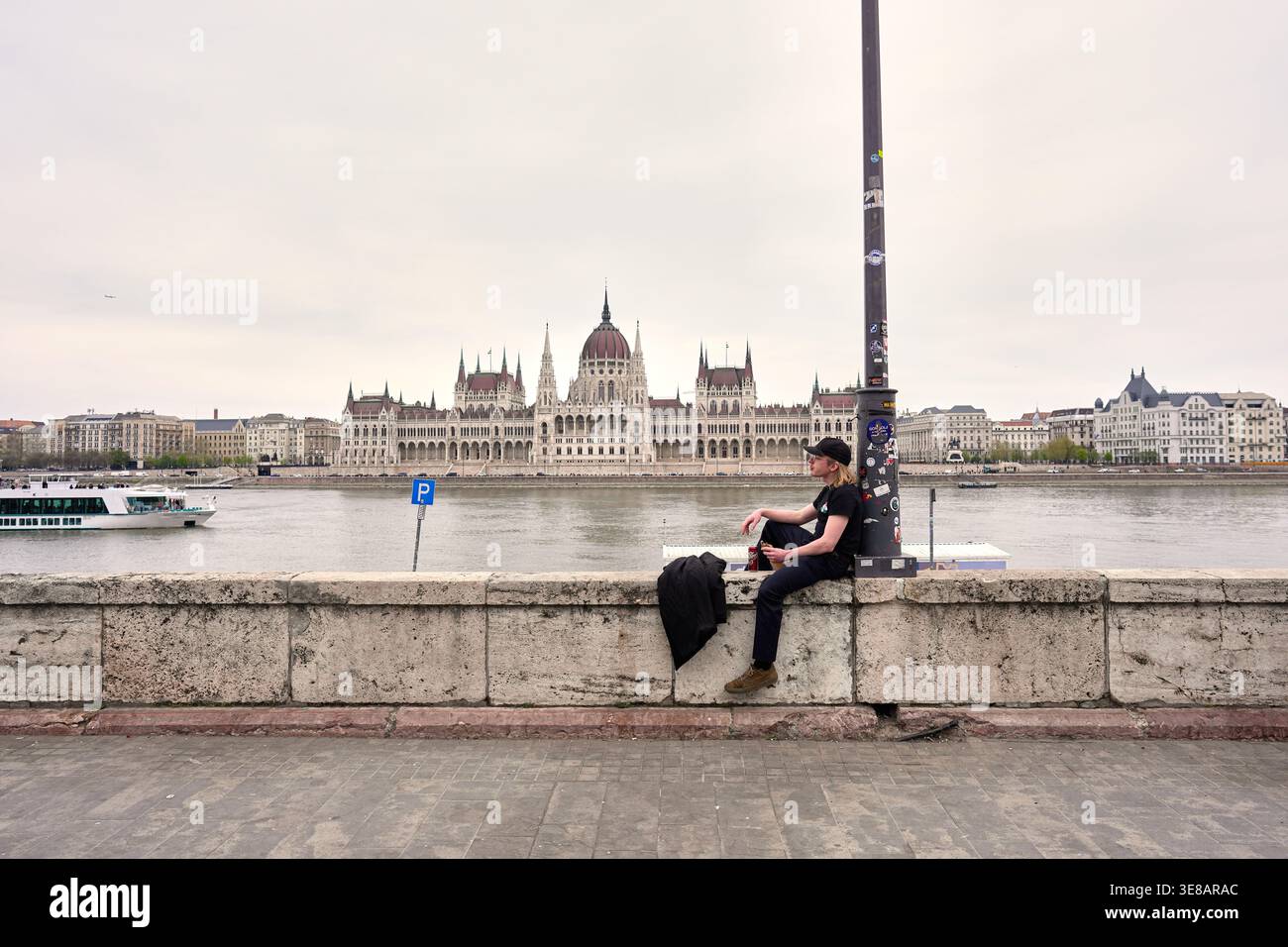Milan, 26 years-old relaxes by the Danube river, backdropped by the ...