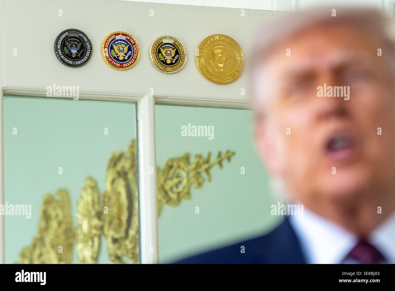 Presidential challenge coins are seen on the door as President Donald ...