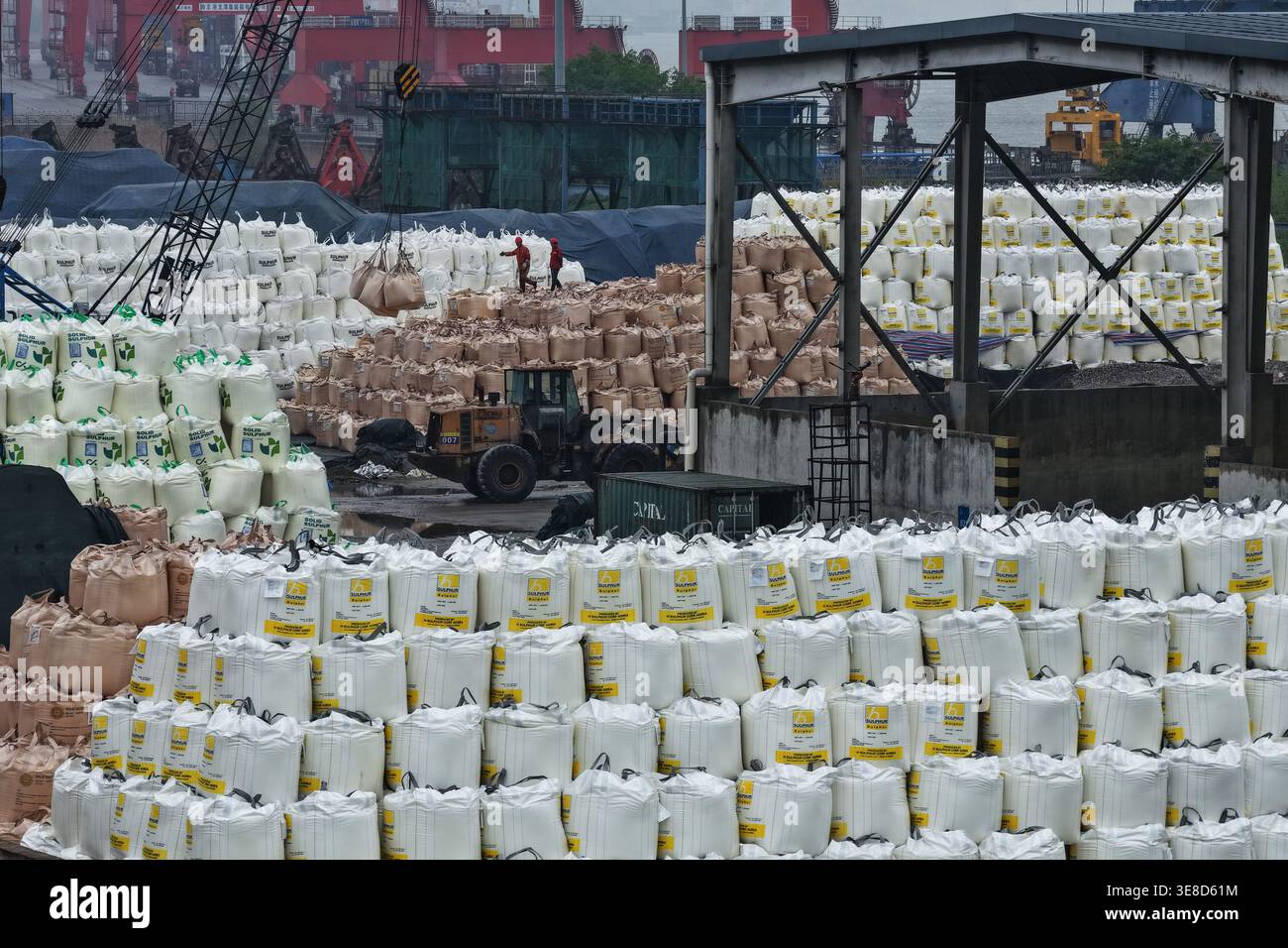 NANJING, CHINA = APRIL 14, 2026 - A sulfur yard at a Yangtze River ...