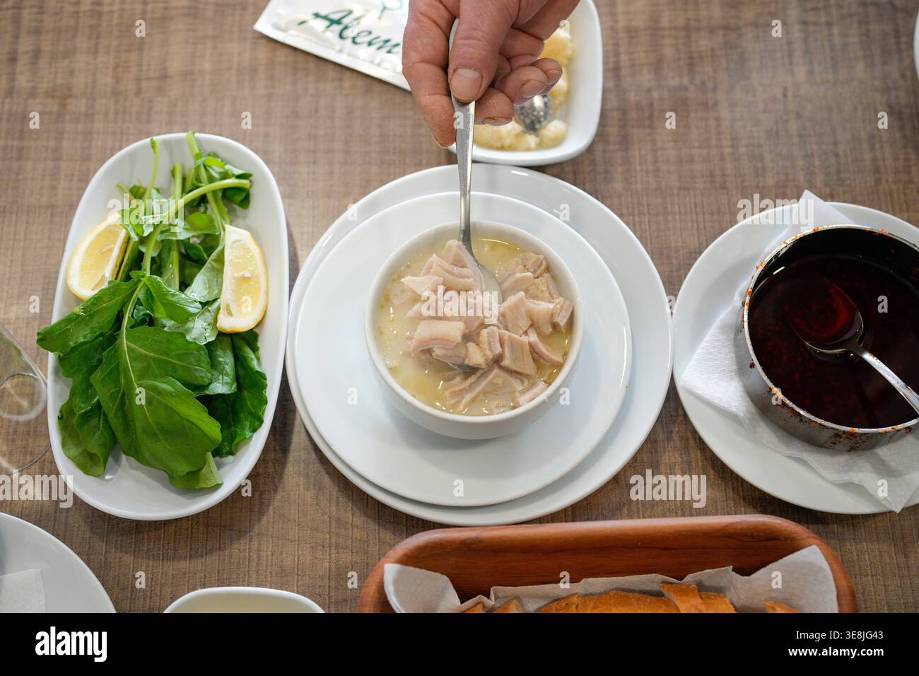 A man prepares to eat traditional tripe soup, known as "iskembe" in ...