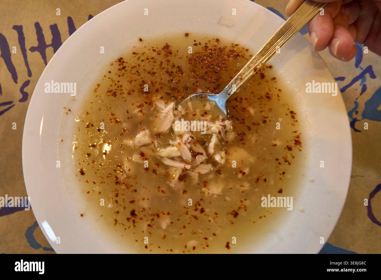 A woman prepares to eat traditional tripe soup known as "patsas" in ...