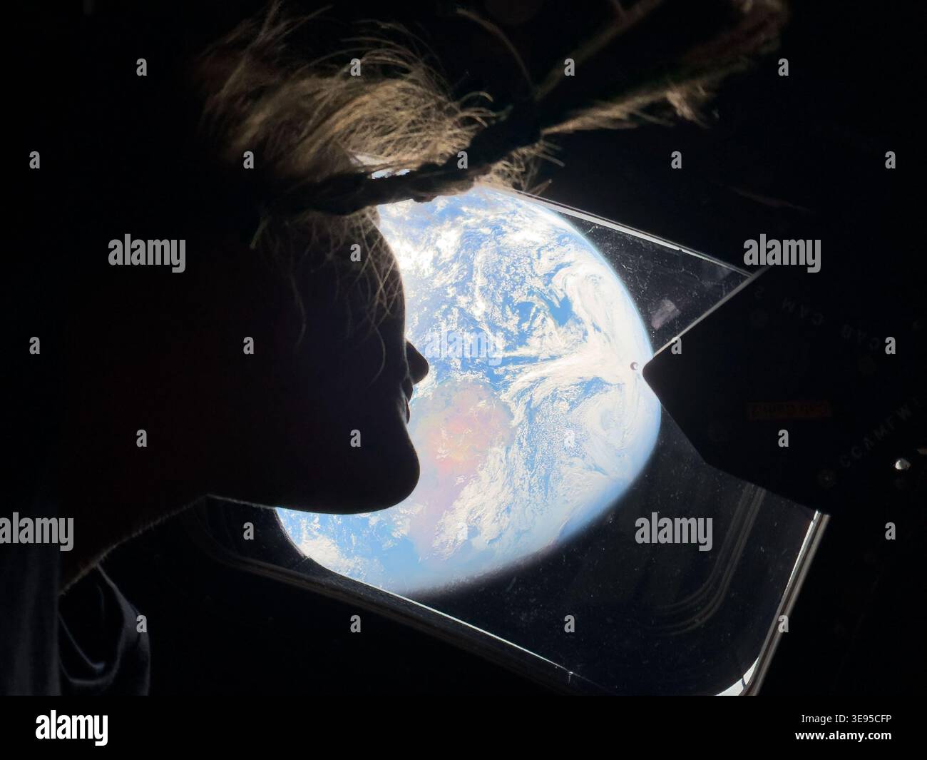 NASA astronaut and Artemis II mission specialist Christina Koch peers ...