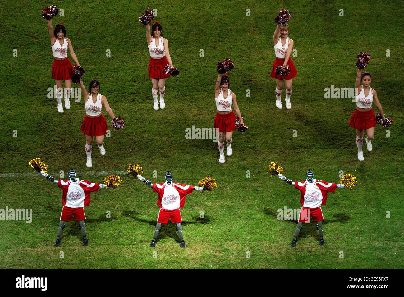 Robots and Cheerleaders performing a dance during the opening ceremony ...