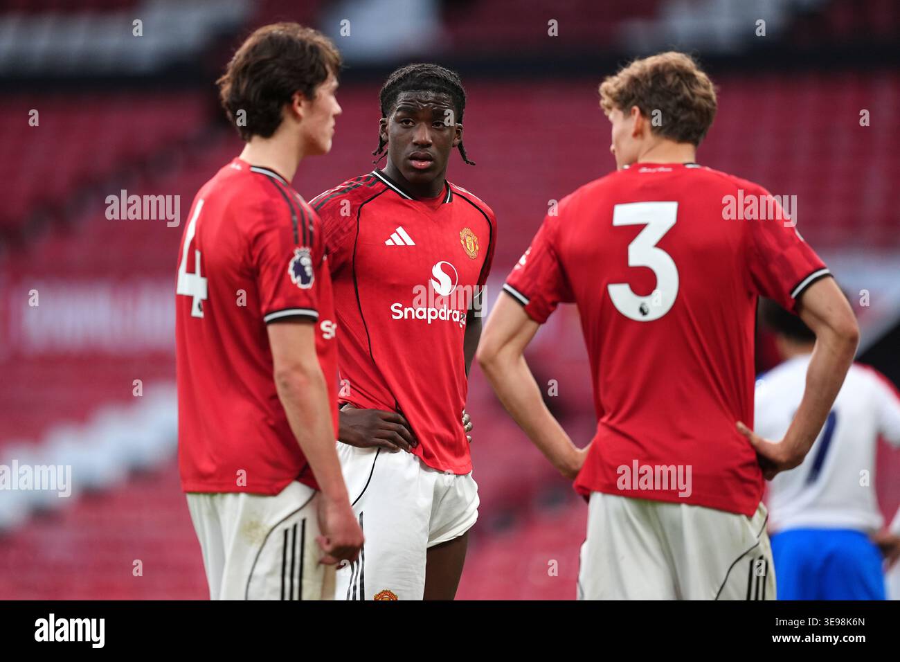Manchester United's Godwill Kukonki (centre) speaking with Daniel Armer ...