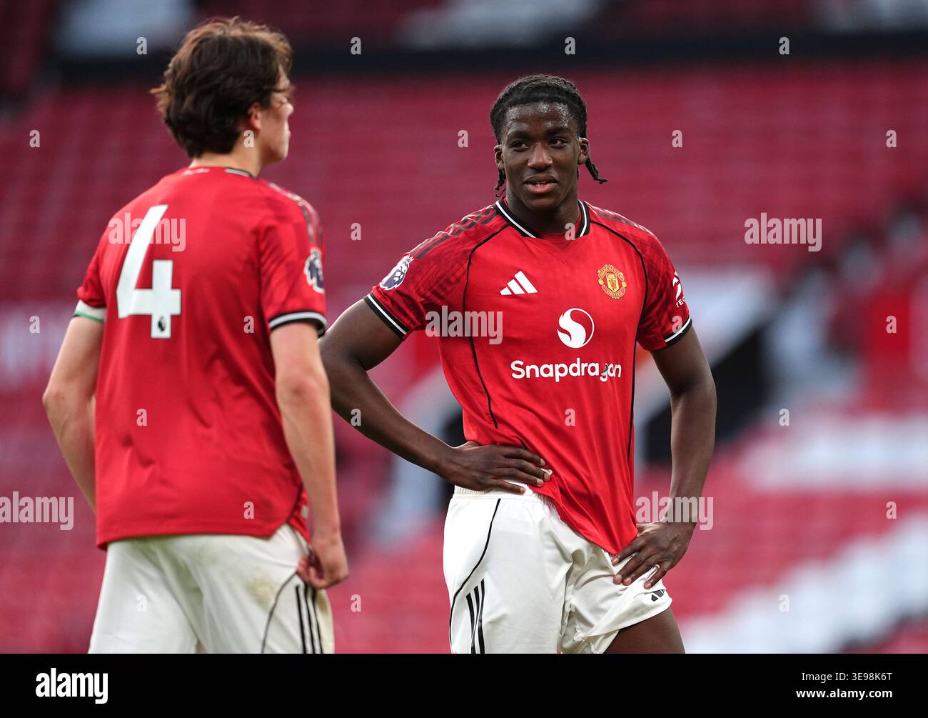 Manchester United's Godwill Kukonki (right) speaking with Daniel Armer ...