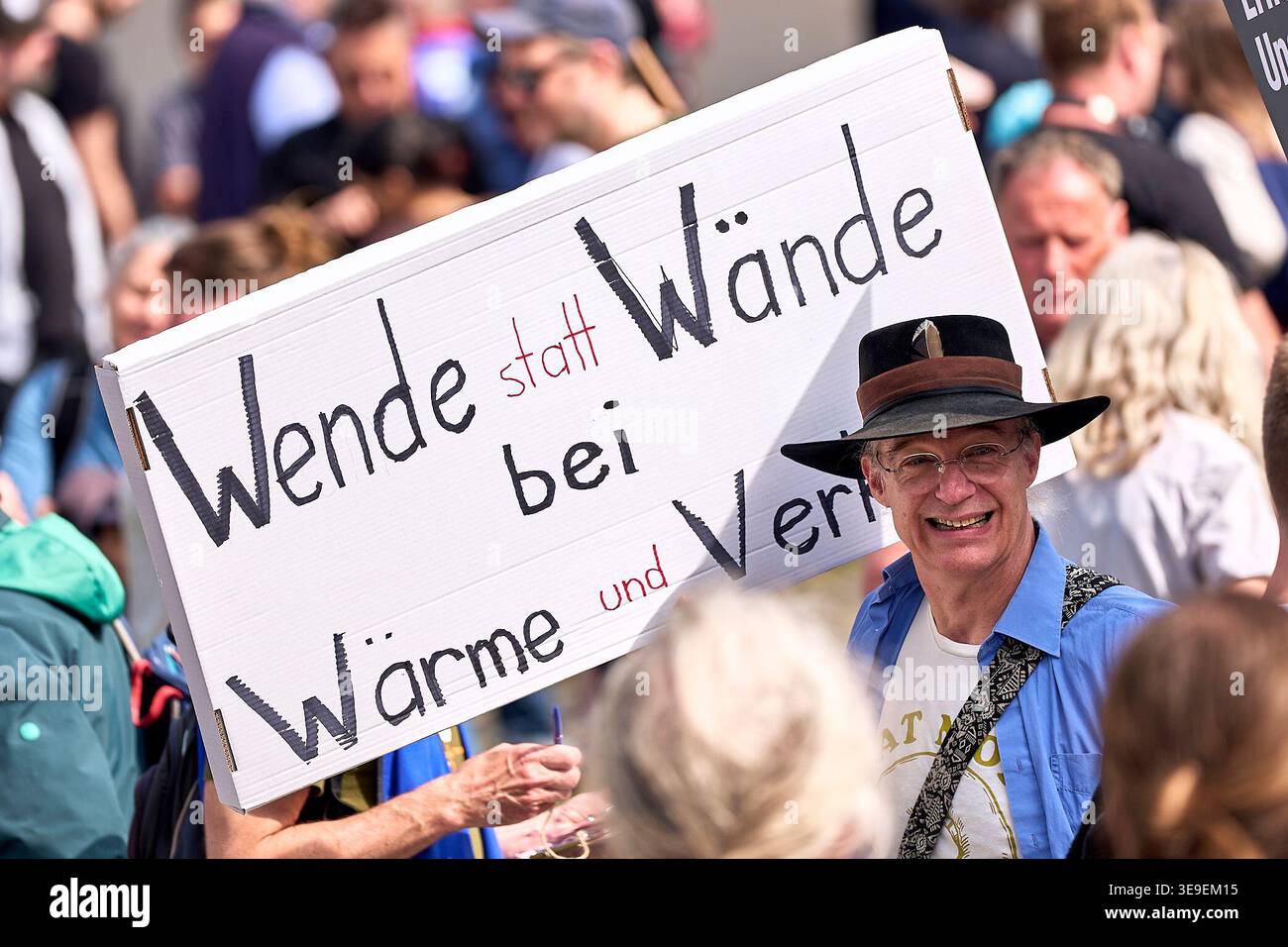 Berlin, Germany. 18th Apr, 2026. A man in a hat stands in a crowd of ...