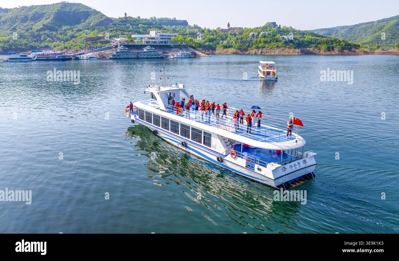 Tourists board a boat to the Yellow River Three Gorges scenic area at ...