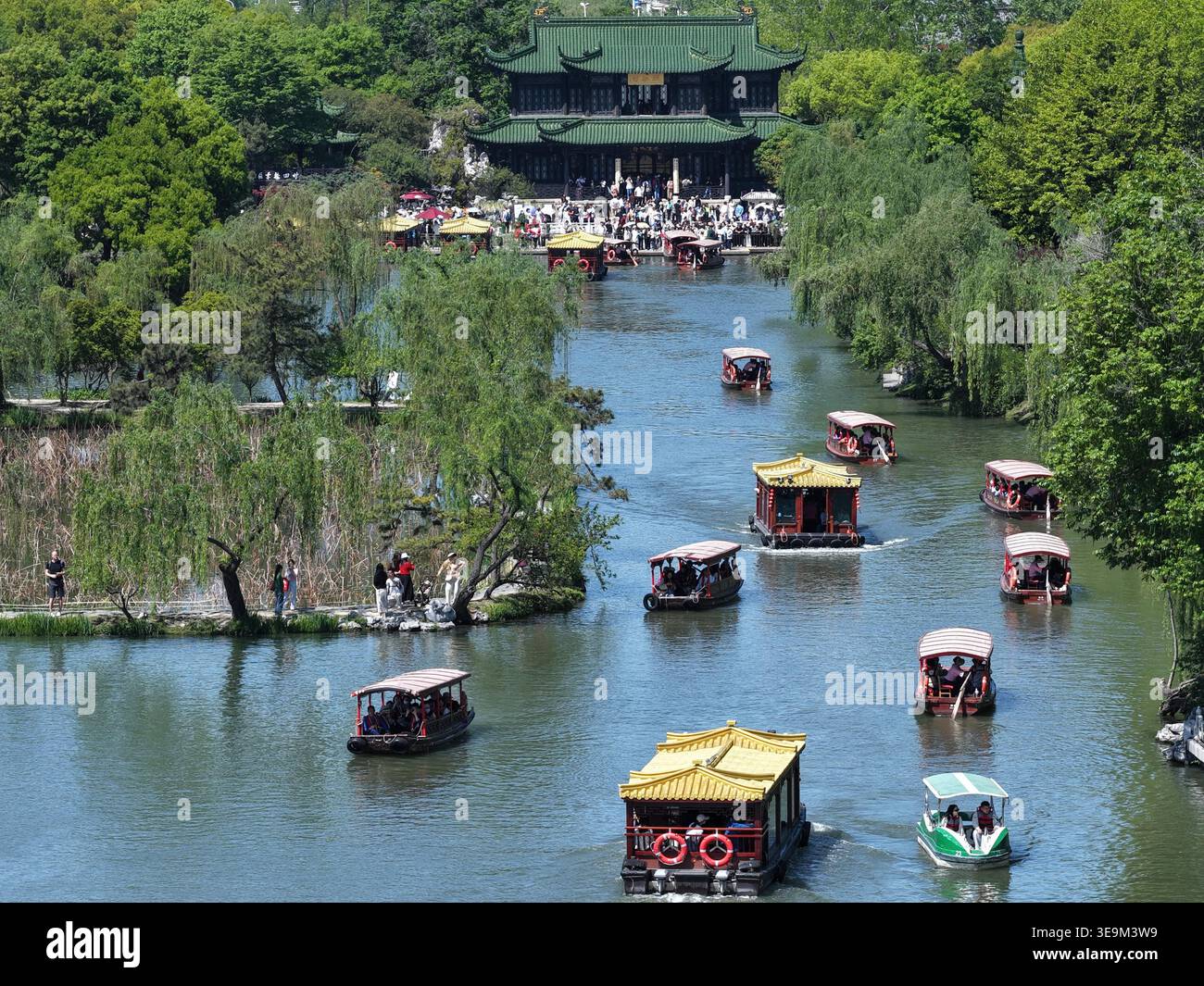 Tourists enjoy the beautiful spring scenery at Slender West Lake in ...
