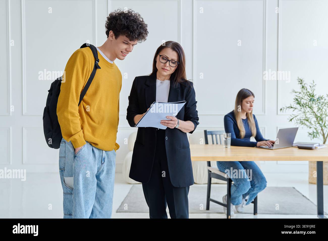 Female mentor teacher and male university student together inside the ...