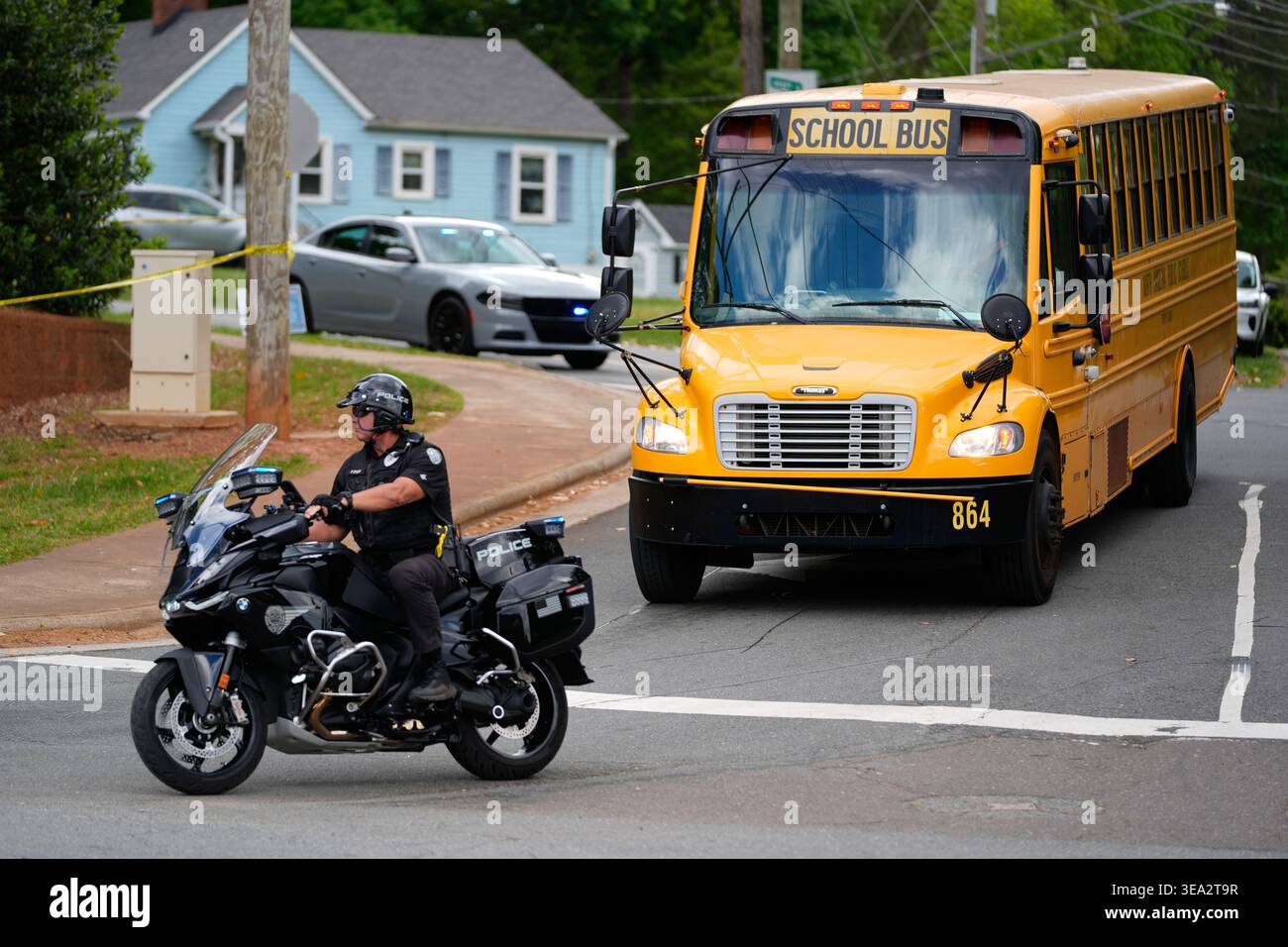 A school bus drives by the scene of shooting at Leinbach Park on Monday ...