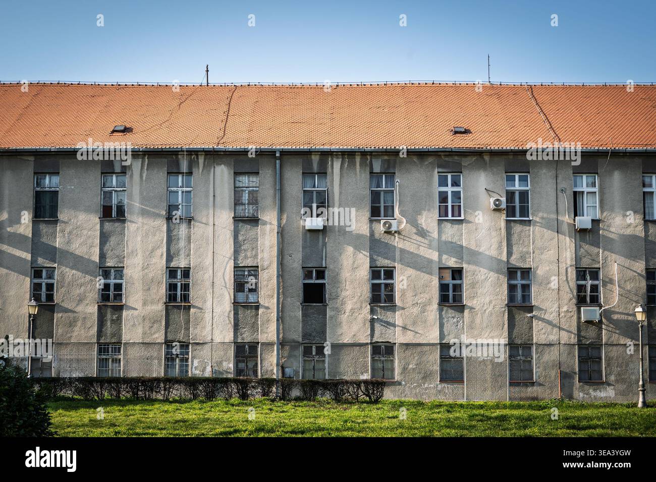 Front view of an old crumbling industrial warehouse in Serbia, with a ...
