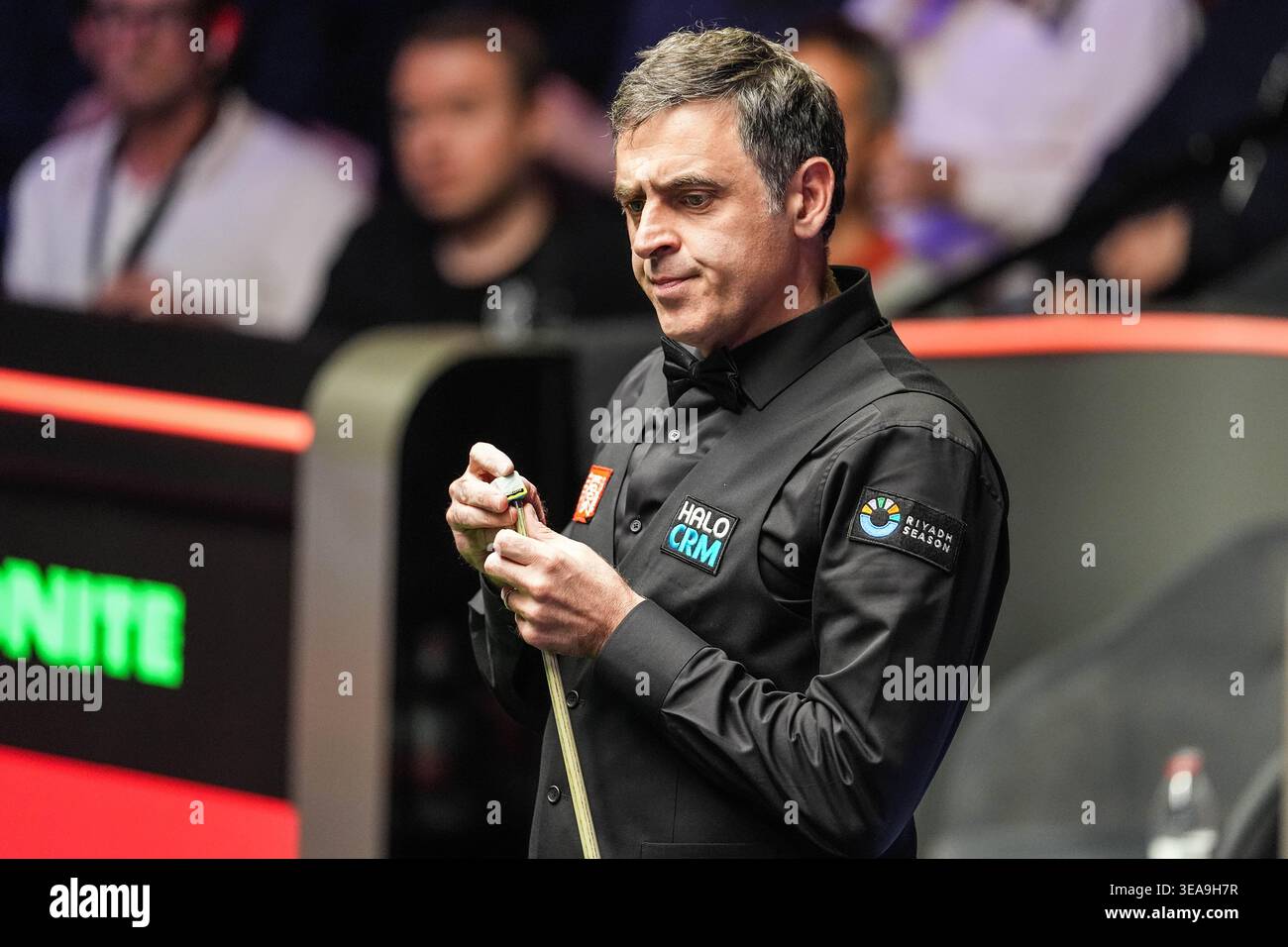 Ronnie O'Sullivan (England) applies chalk to his cue during Round 1 of ...
