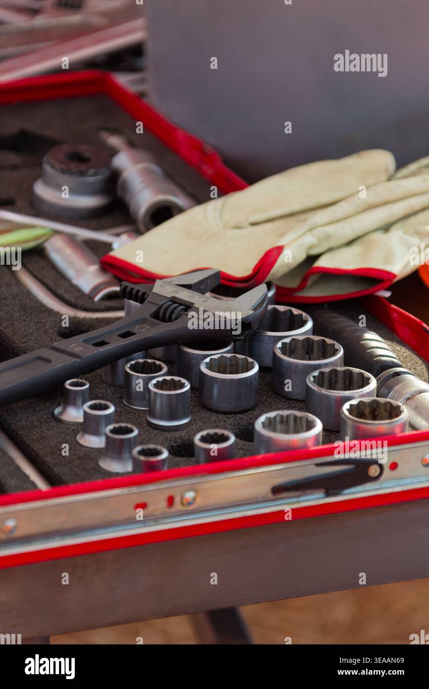red metal tool chest drawer contains an organized set of steel sockets ...