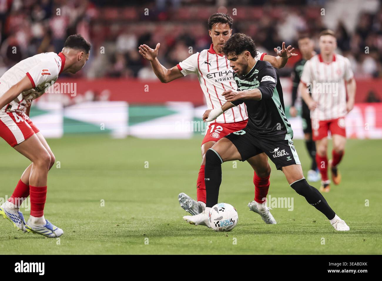 Cucho Hernandez of Real Betis and Vitor Reis of Girona during the ...