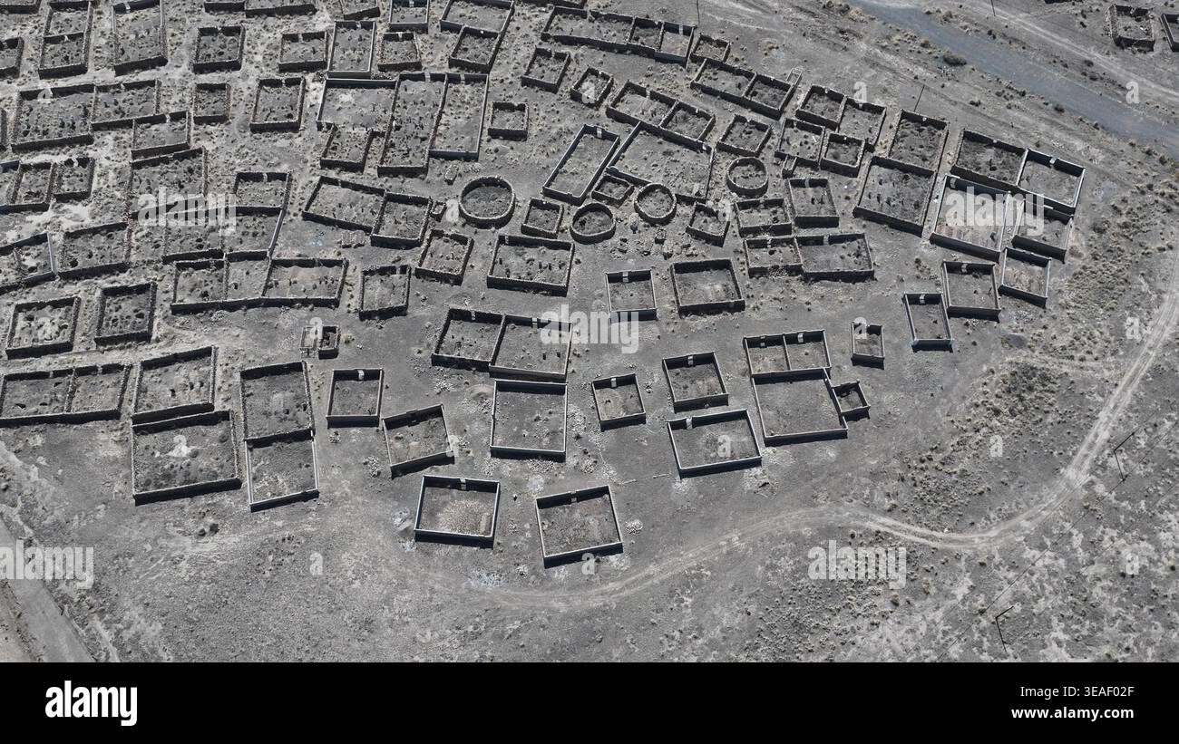 A maze-like sheepfold built with layered stones stands in the ...