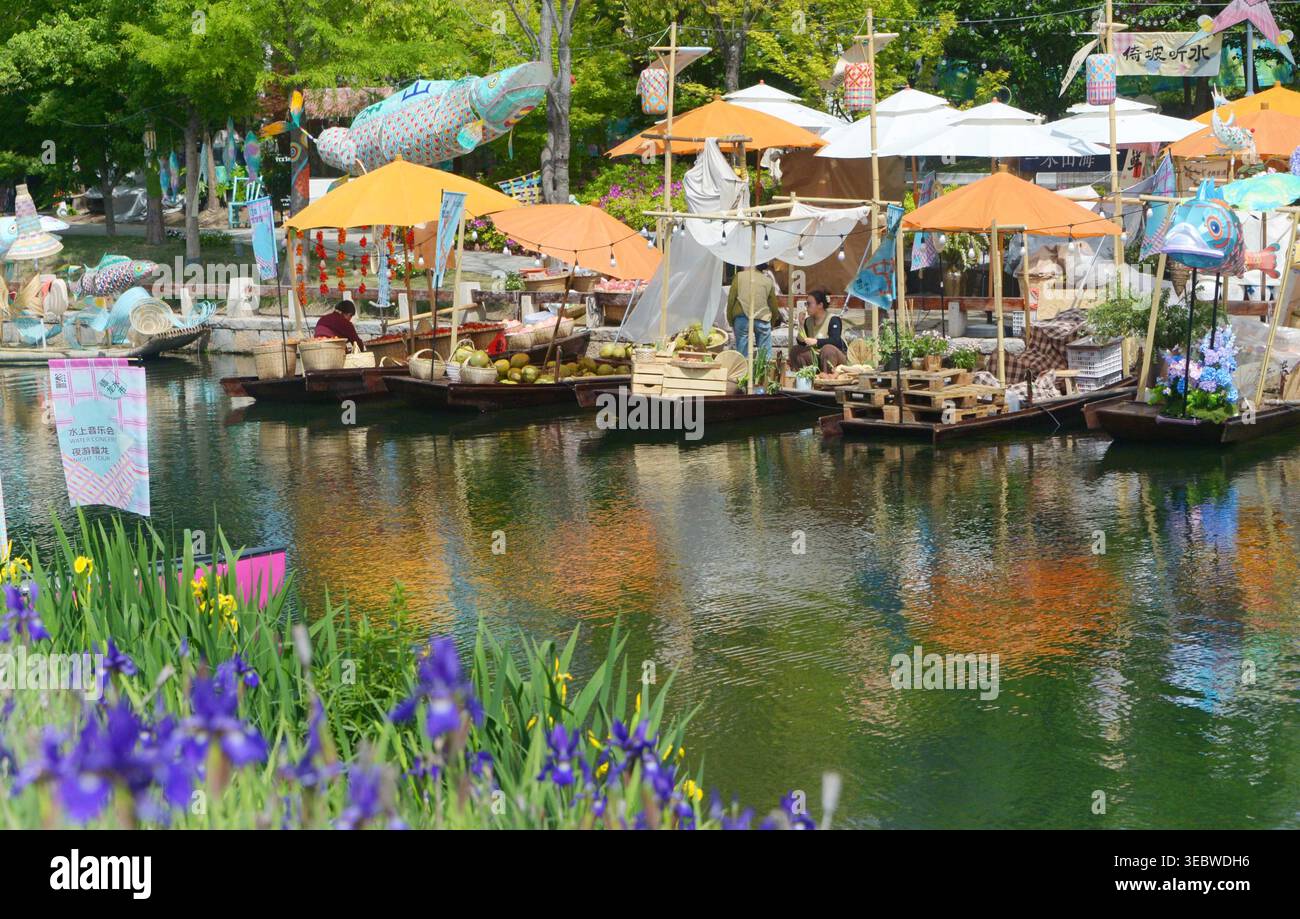 Visitors explore the waterfront market at Panlong Tiandi during the 3rd ...