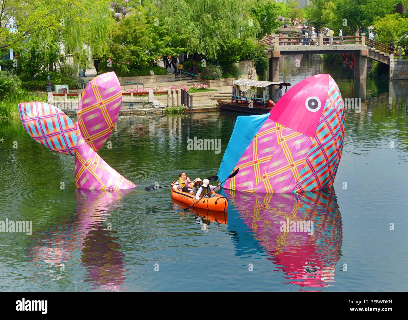 Visitors explore the waterfront market at Panlong Tiandi during the 3rd ...