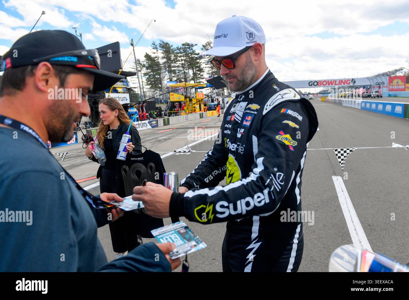 Shane Van Gisbergen (97) signs an autograph before a NASCAR Cup Series ...