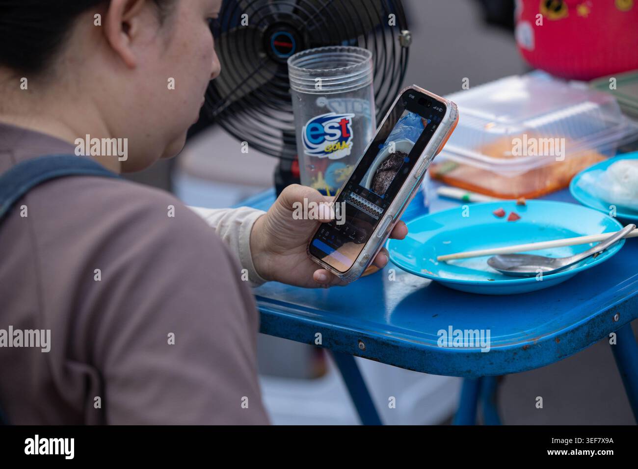 PHAYAO, THAILAND-APR 11, 2026: Woman using smartphone while resting ...