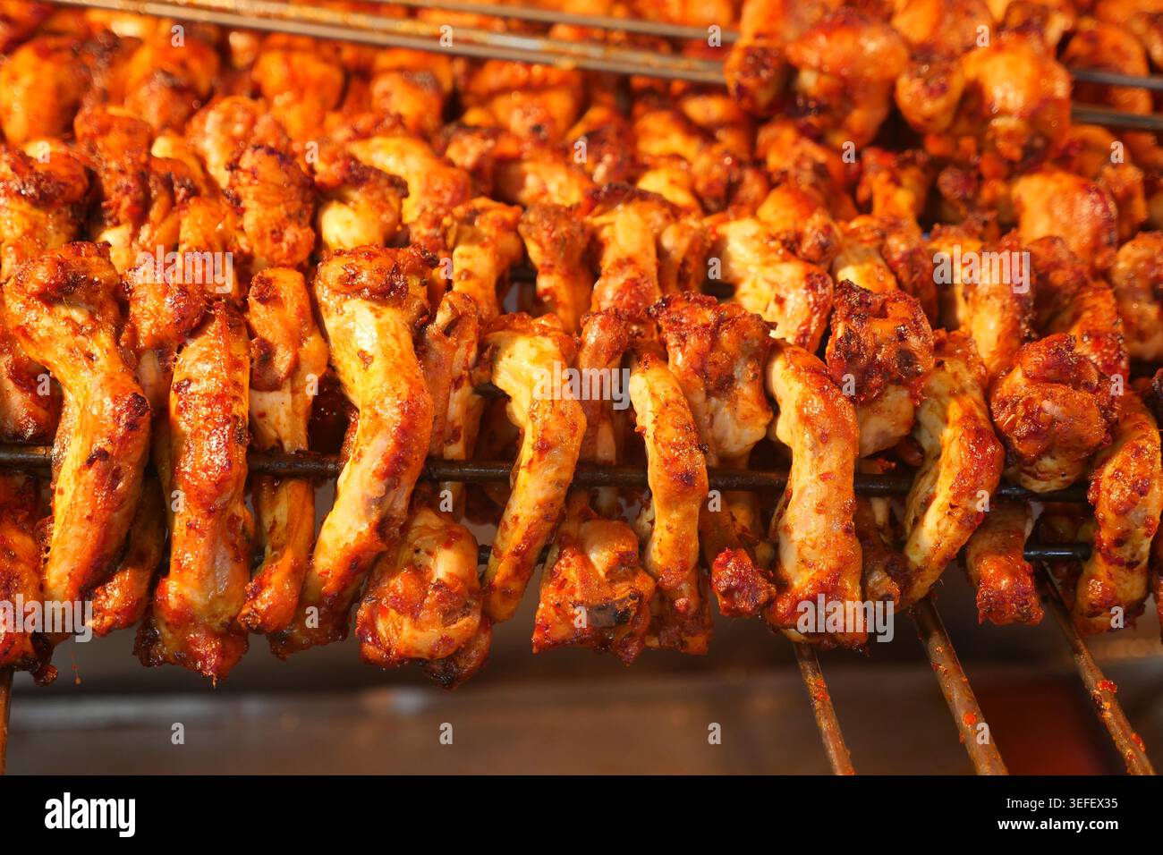 Grilled chicken wings on a rack at the market Stock Photo - Alamy