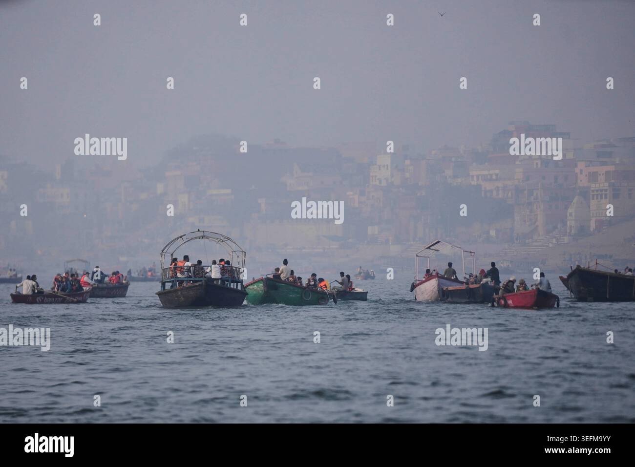 FILE - Tourists take a boat ride early morning in the Ganges river in ...