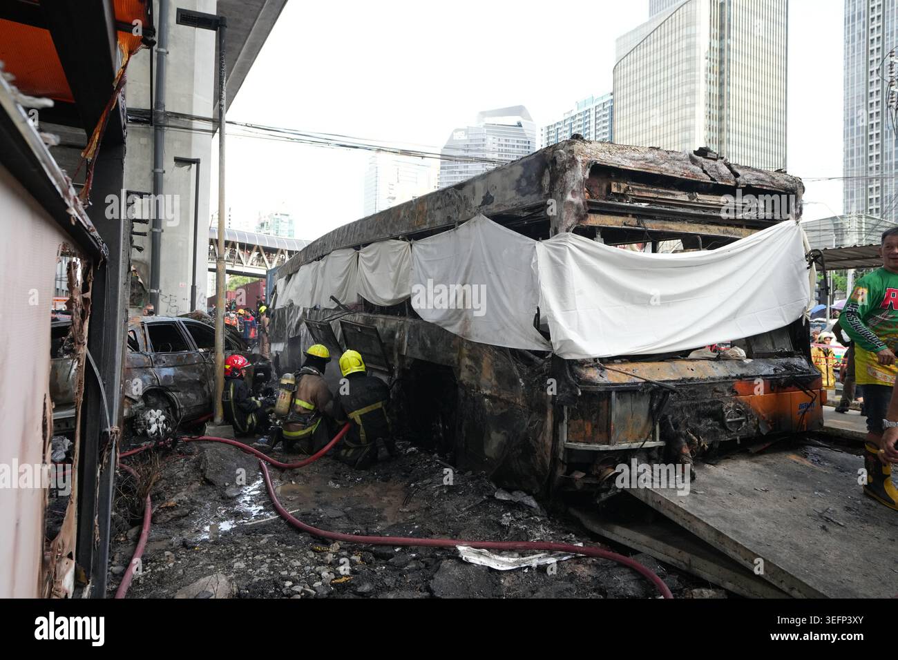 Firefighters work at a train crash site near an airport rail link ...