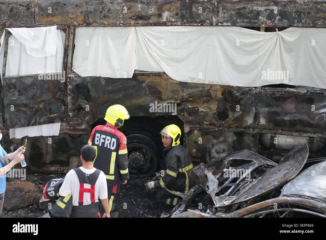 Firefighters work at a train crash site near an airport rail link ...