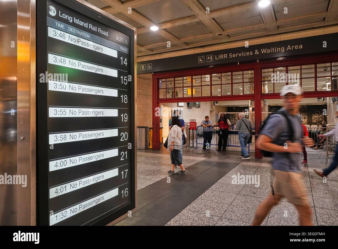 Rail passengers pass the Long Island Rail Road waiting room in Penn ...