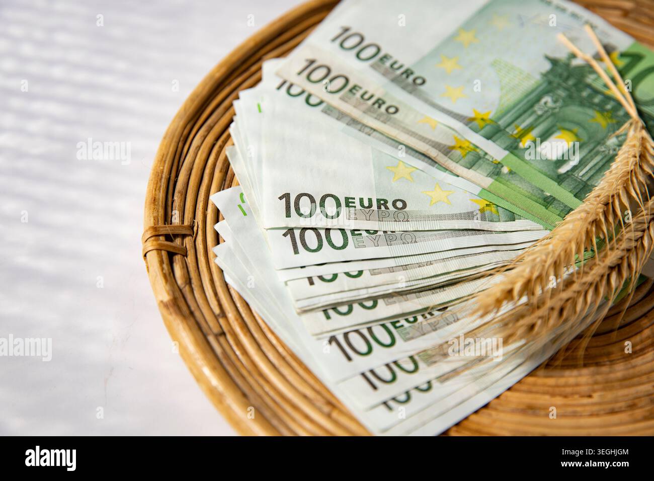 Euro banknotes with wheat ears on wicker tray in sunlight Stock Photo ...