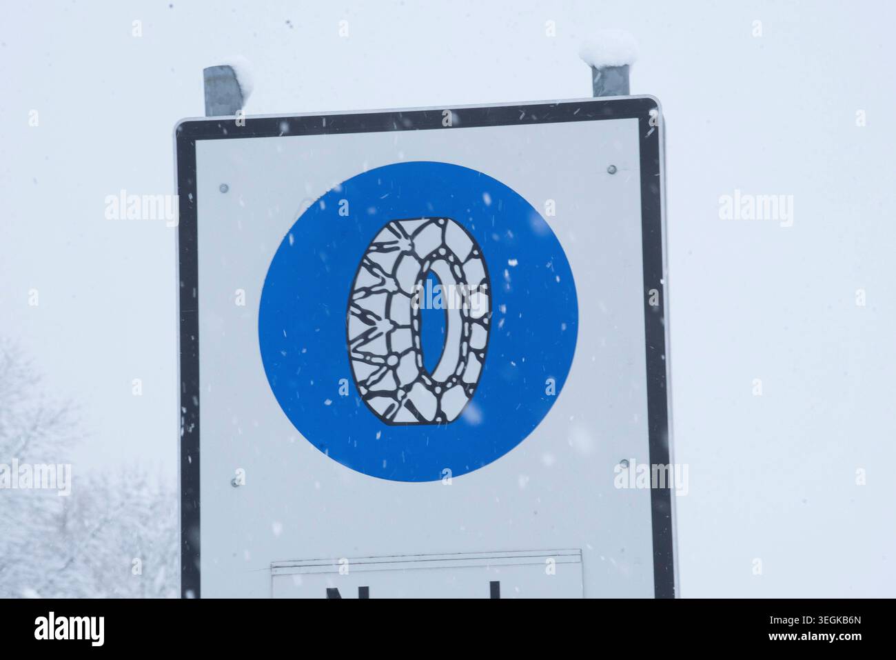 snow chains on a vehicle tire, snow chain obligation in winter snow ...