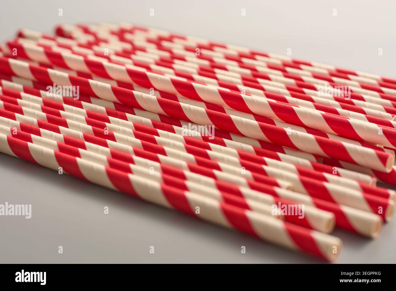 pile of striped paper drinking straws on grey background, close up view ...